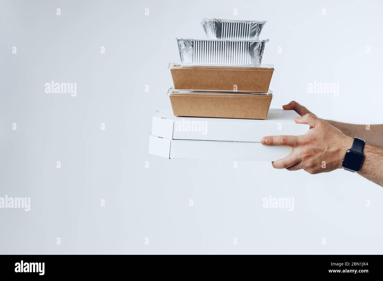 Courier hands giving packed food delivery close up Stock Photo - Alamy