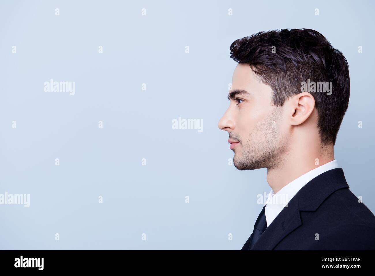 Side profile photo of a young handsome brunete realtor with bristle in ...