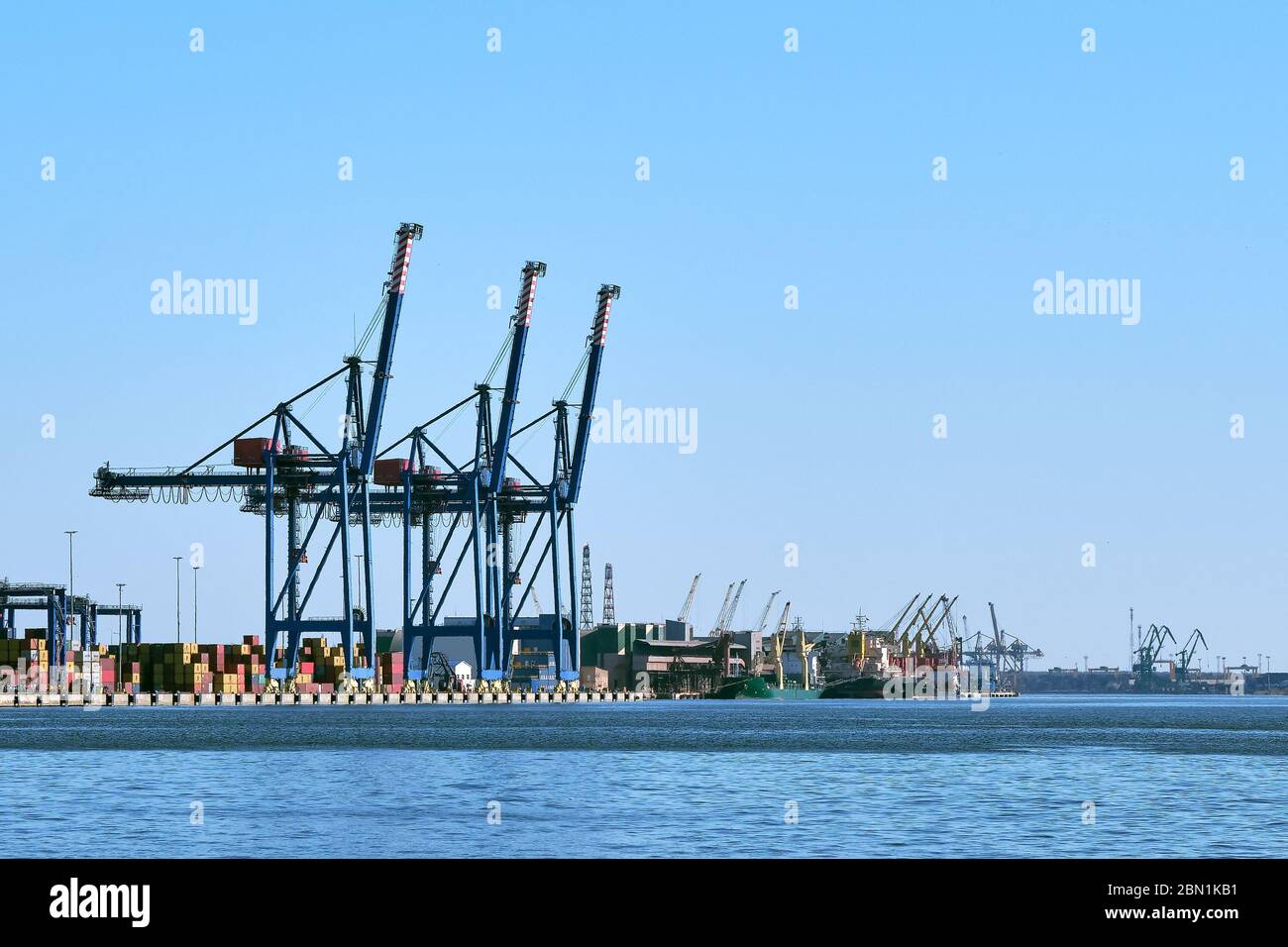 View of port cranes, loading bridges and container terminal on a clear ...