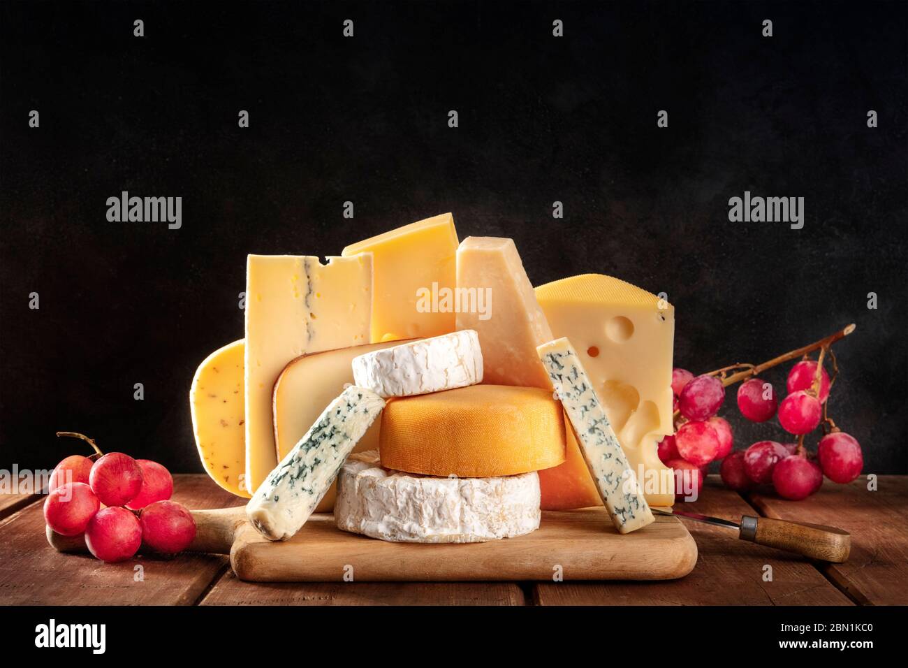 Cheese variety, many different types of cheeses with grapes, a side ...