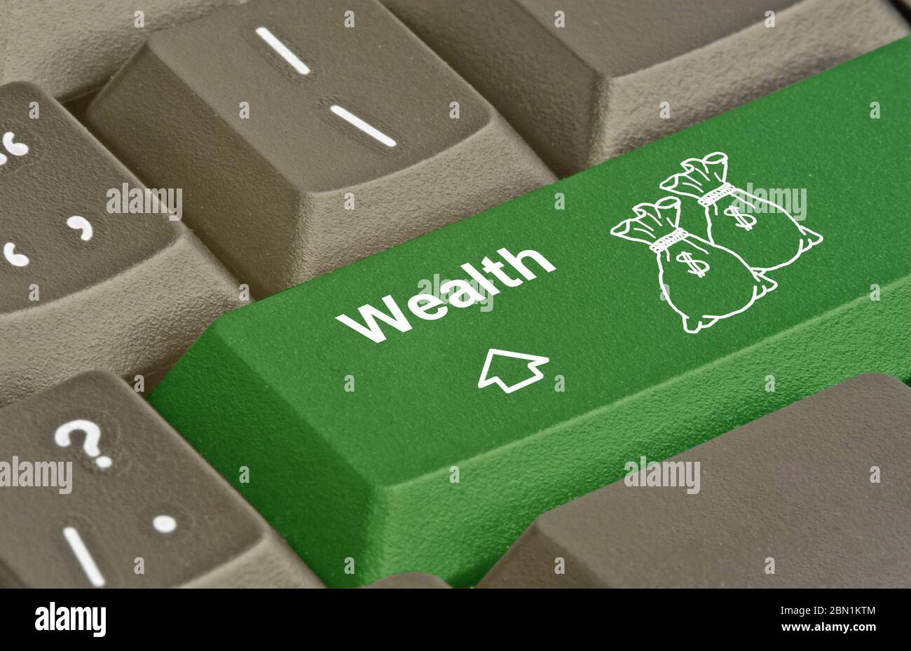 Keyboard with key for wealth Stock Photo - Alamy