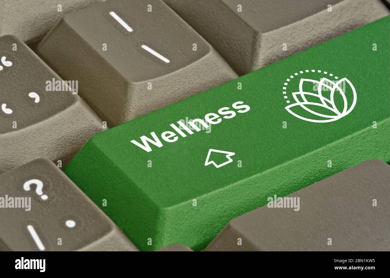 Keyboard with key for wellness Stock Photo - Alamy