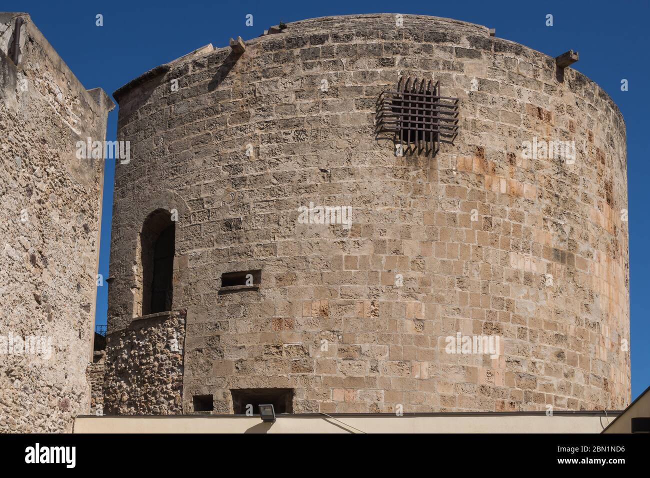 Round building of the fortification tower made of stones with small ...