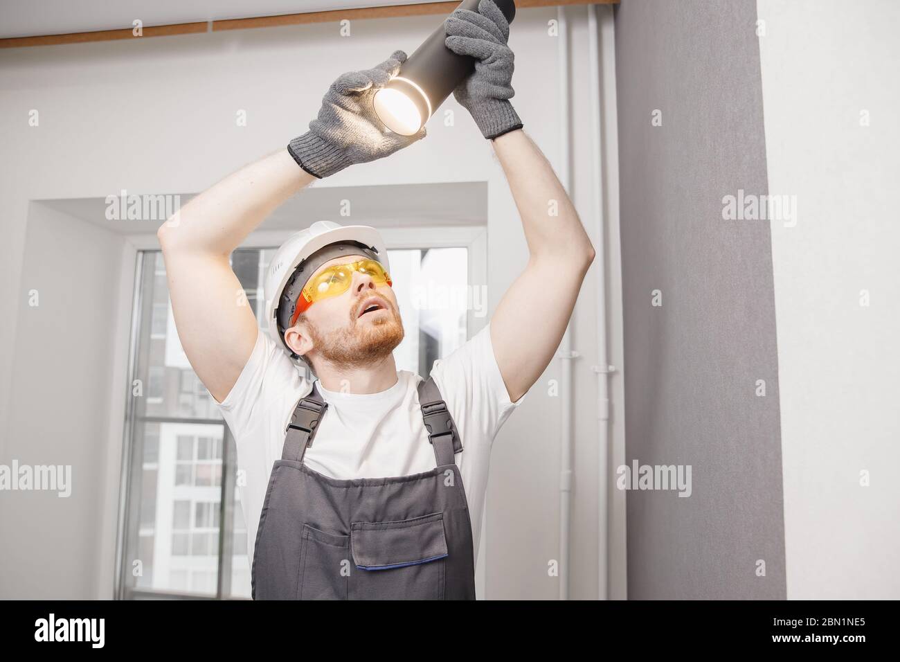 Electrician is repairing lighting fixtures for lamp and spot loft style ...