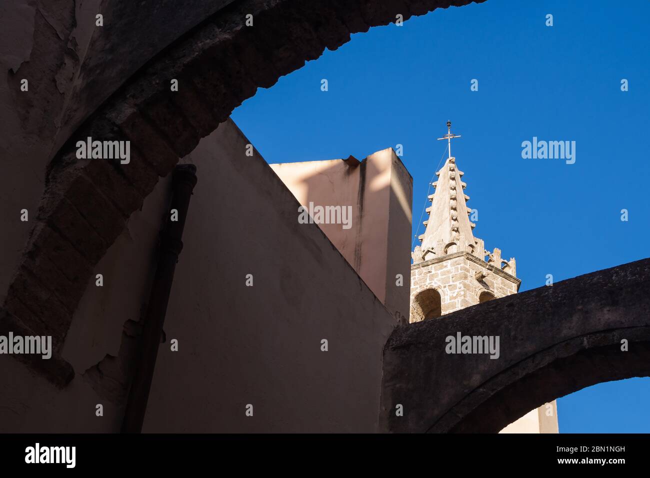 View from a street with archs between buildings on a tower of San ...