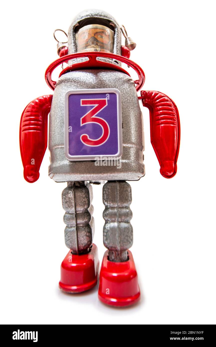 Vintage tin robot toy isolated on a white background Stock Photo - Alamy