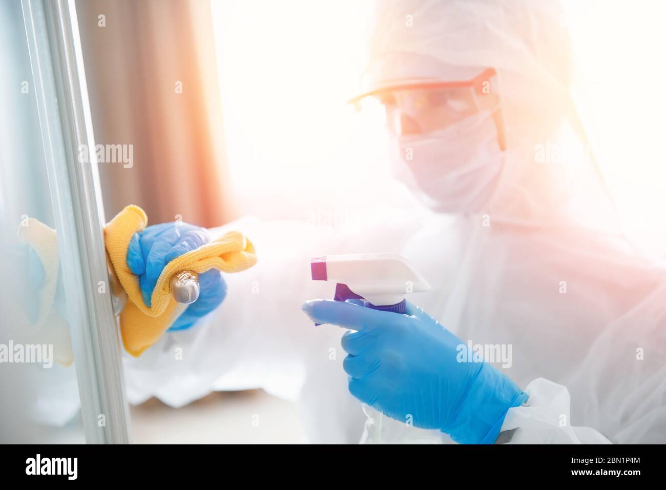 Disinfection and cleaning door handles of house from infection with ...