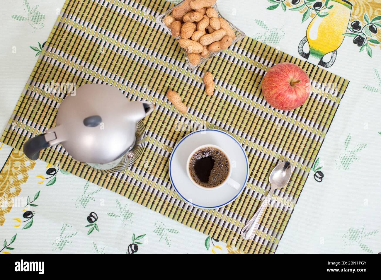 Portuguese cup of expresso coffee with goober peanuts and fruit on a ...