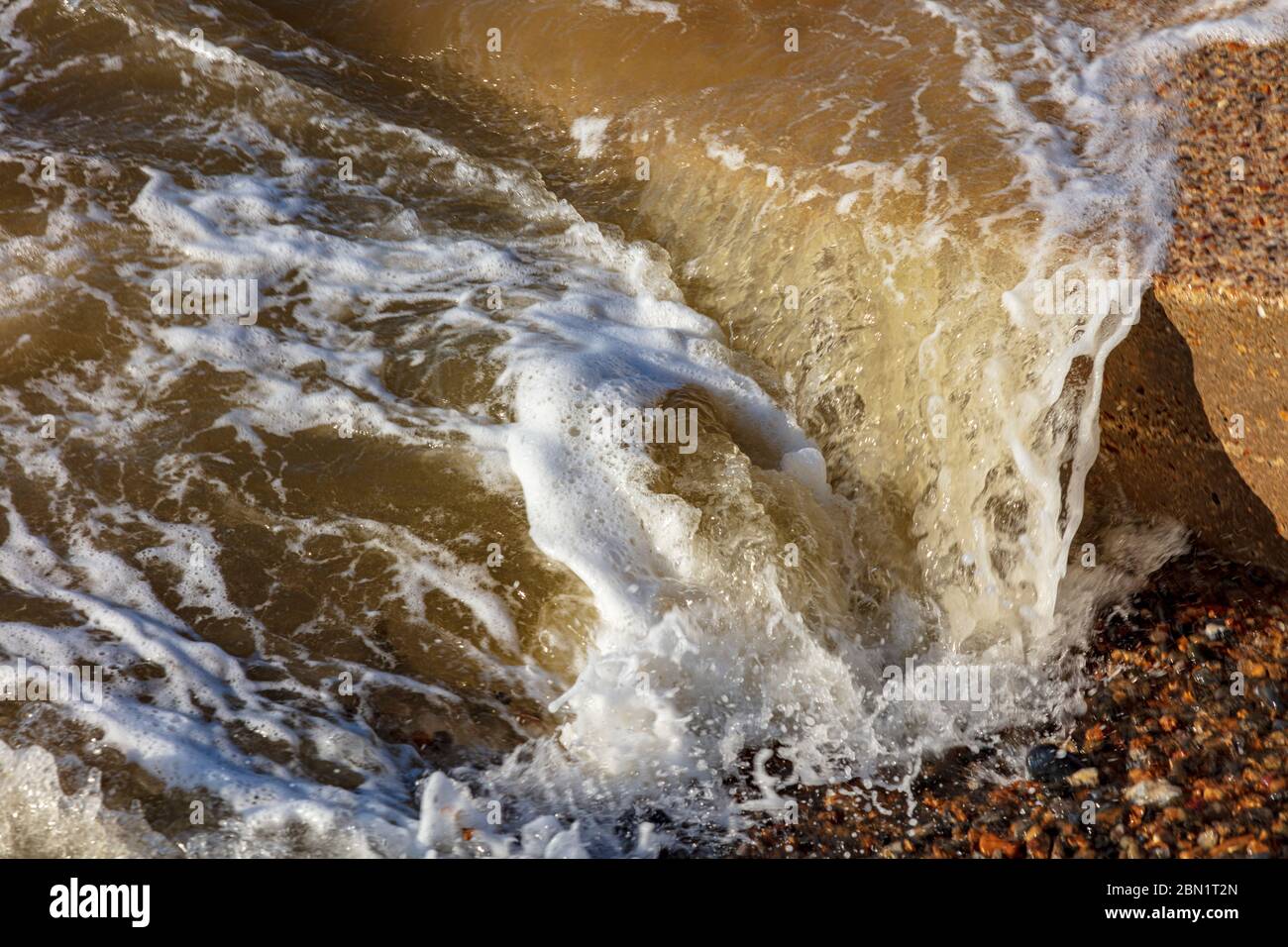 Water swirls over a concrete ramp at Hampton, Herne Bay, Kent, uk Stock ...
