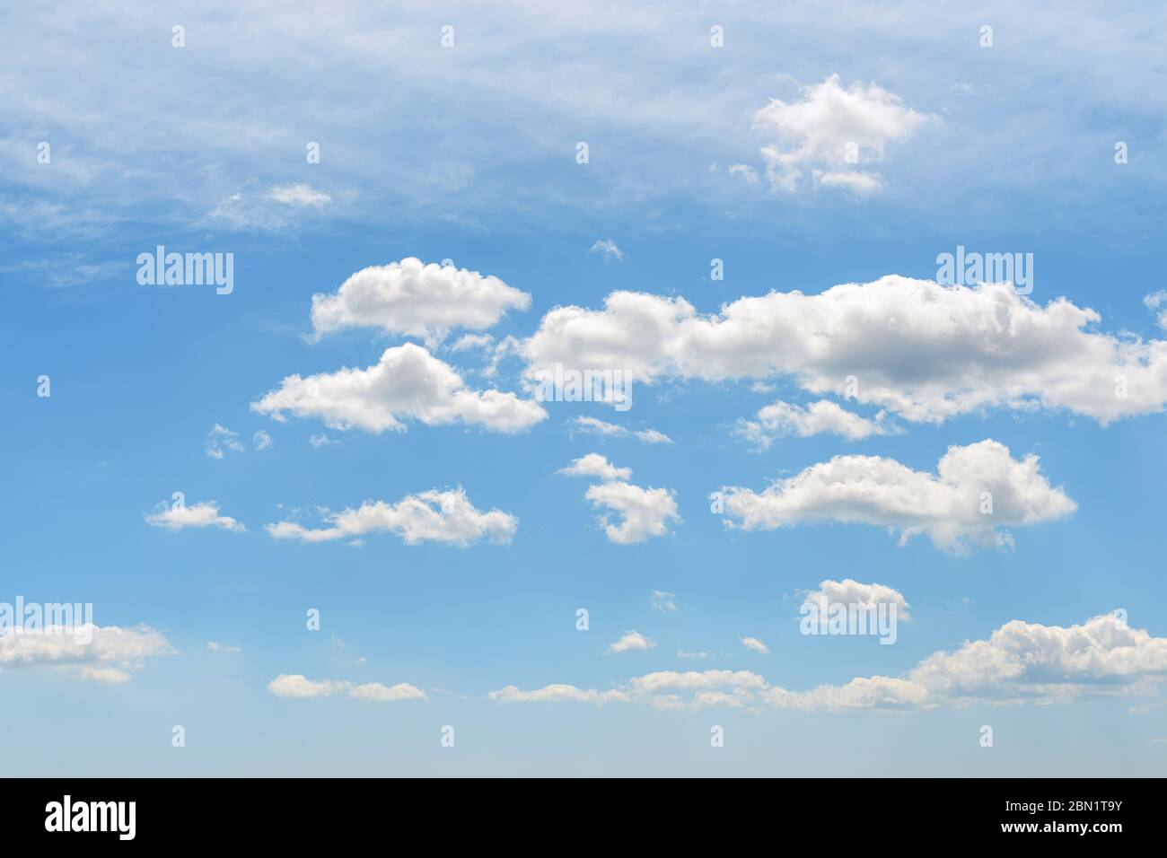 Light translucent cirrus and stratus clouds high in the blue summer sky ...