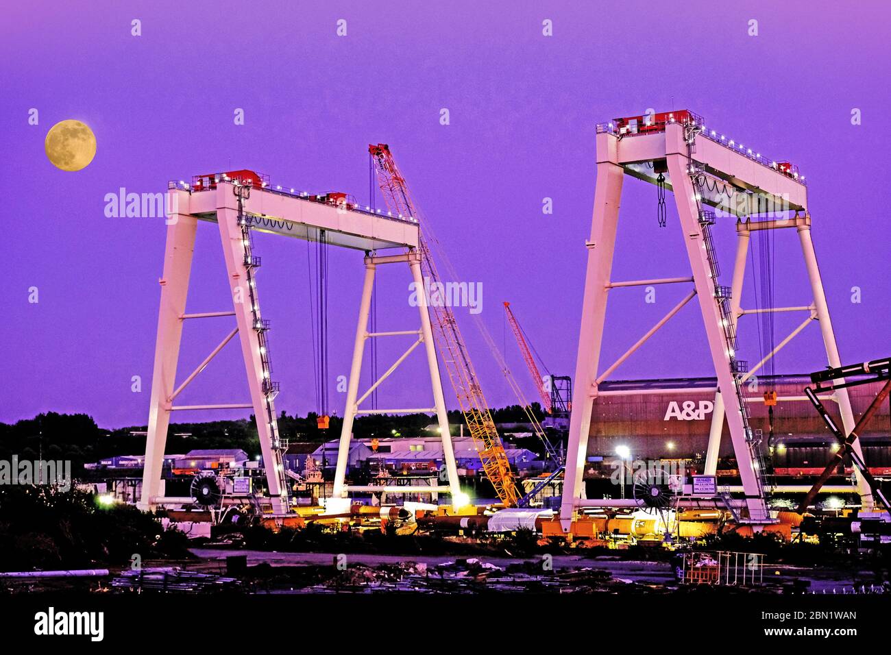 Massive cranes for lifting wind turbine parts during moonlight Stock ...