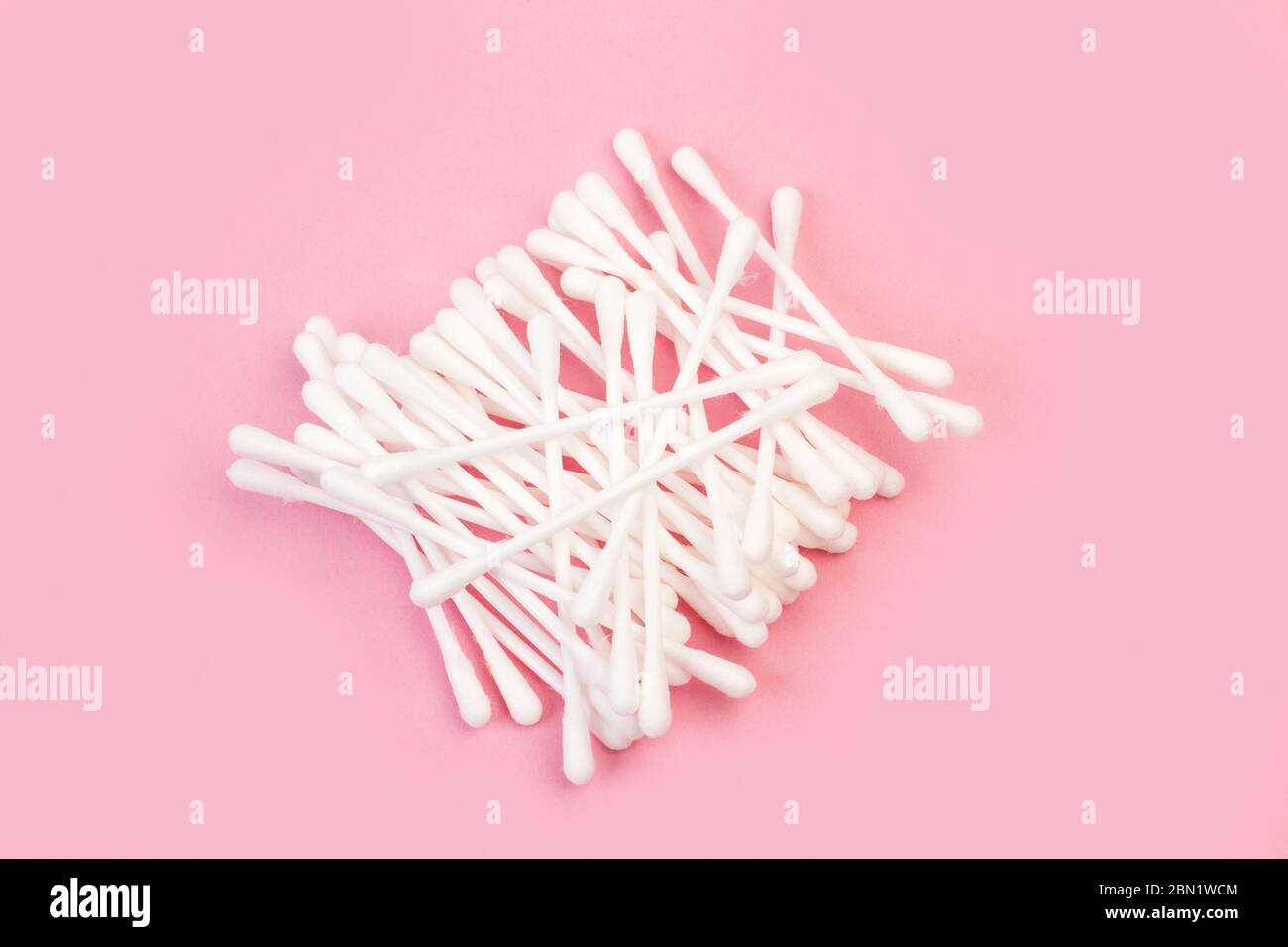 A heap of cotton swabs on a pink background in a top view Stock Photo ...