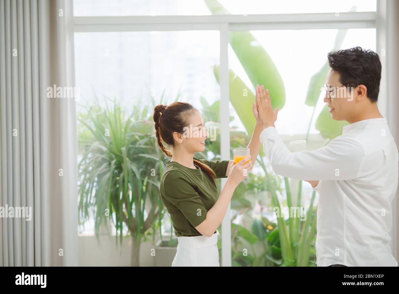 situation in office - two workers giving high five Stock Photo - Alamy