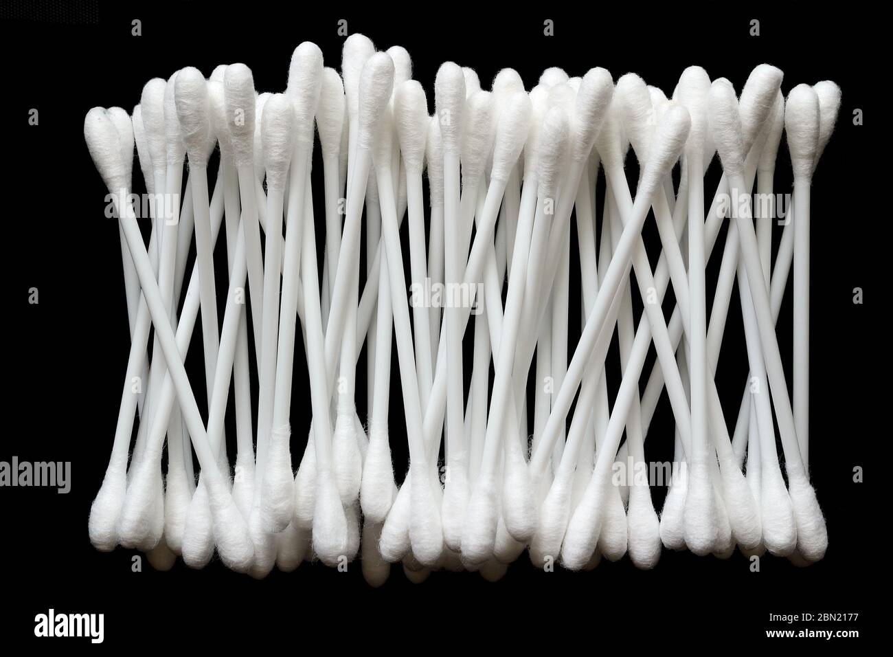 White cotton buds are stacked together on a black background Stock ...