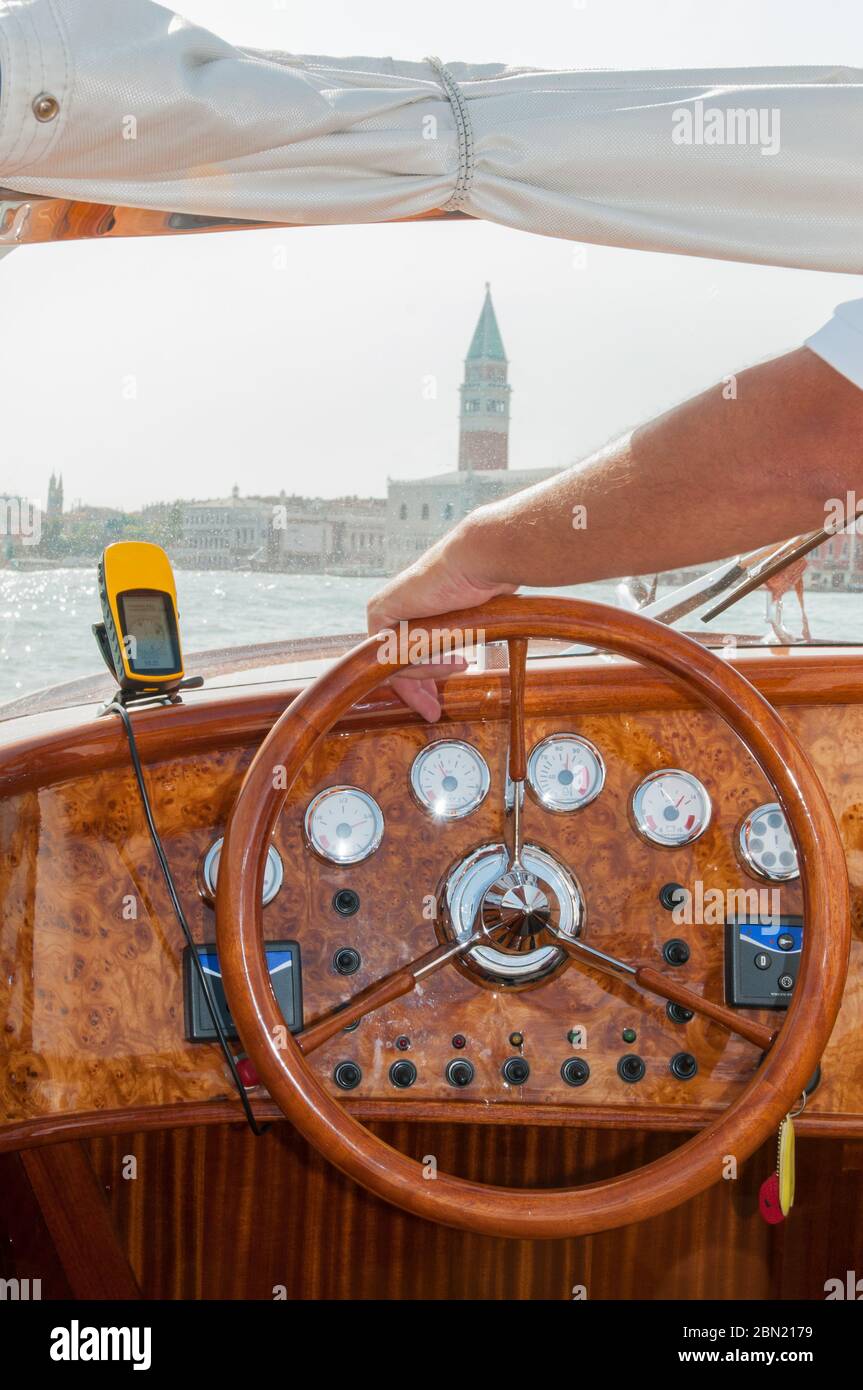 Italian man navigating on a boat, Venice, Italy Stock Photo - Alamy