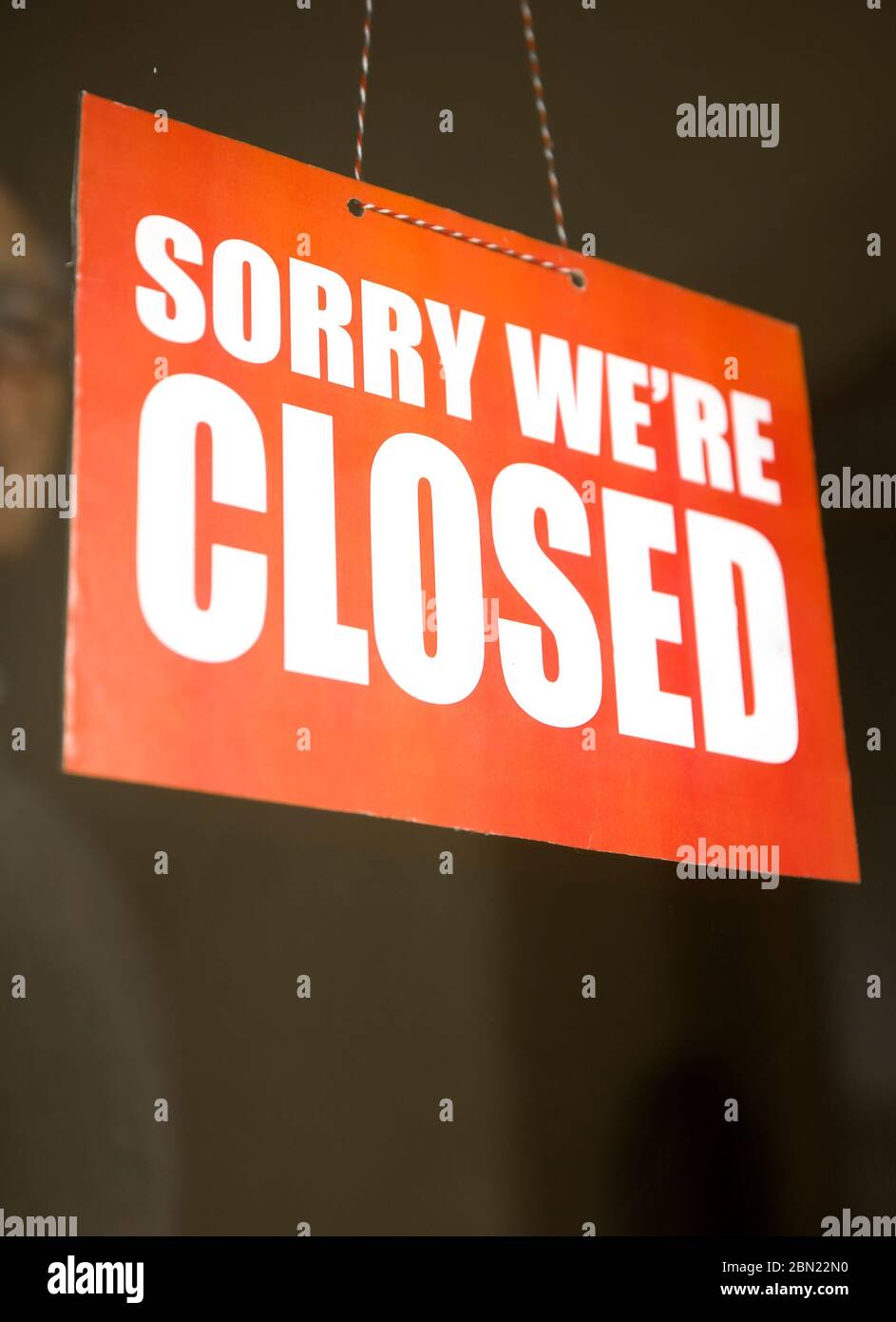 Closed sign board hanging on the glass door of cafe or small store ...