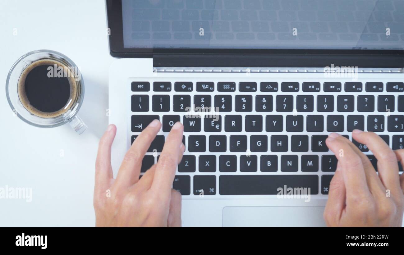 Tapping laptop close up. Man hands typing on the keyboard. Working from ...