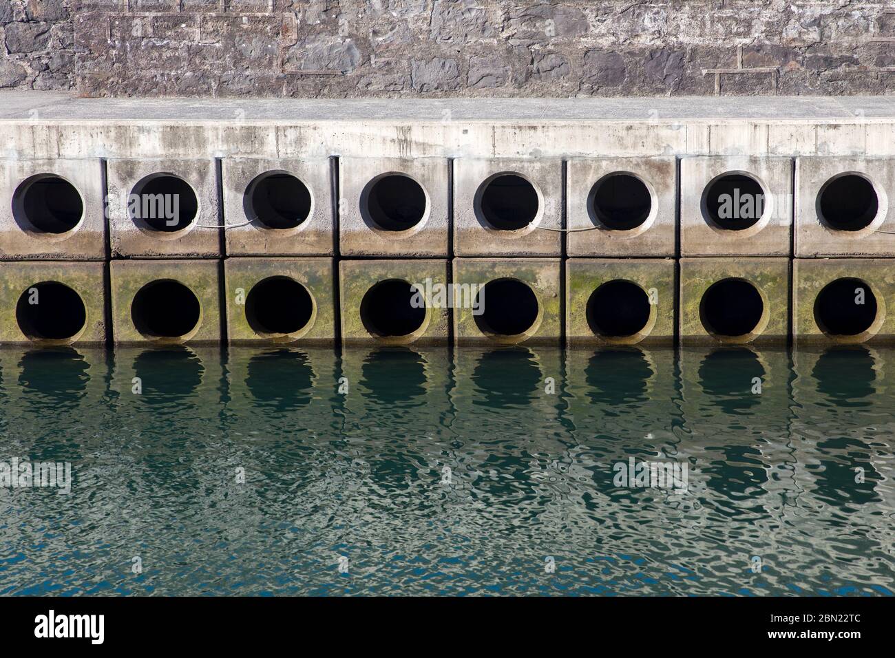 Concrete blocks on the quayside at Funchal harbour on Madeira Island ...