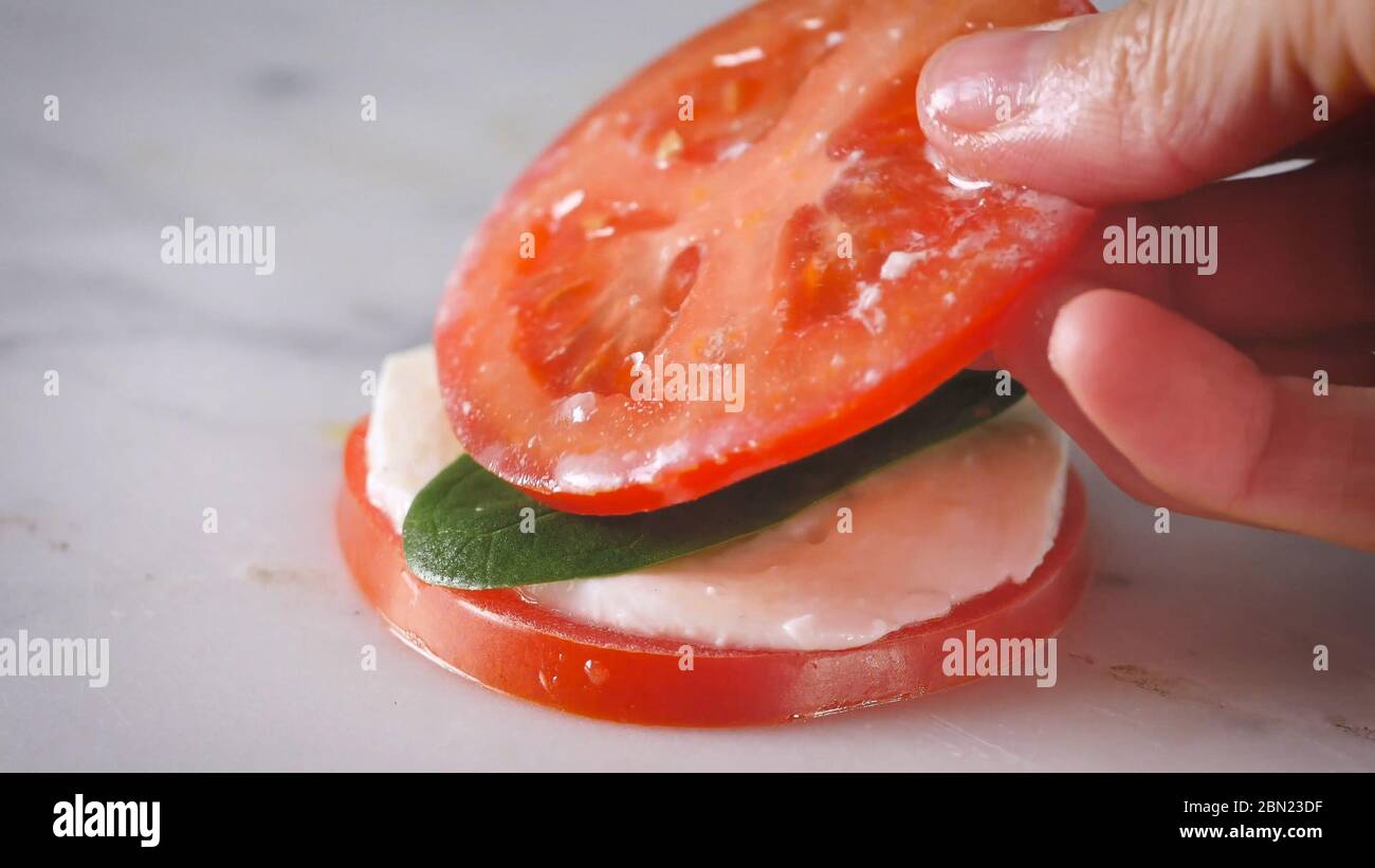 Preparing sandwich, tower caprese salad. Healthy vegetarian salad with ...