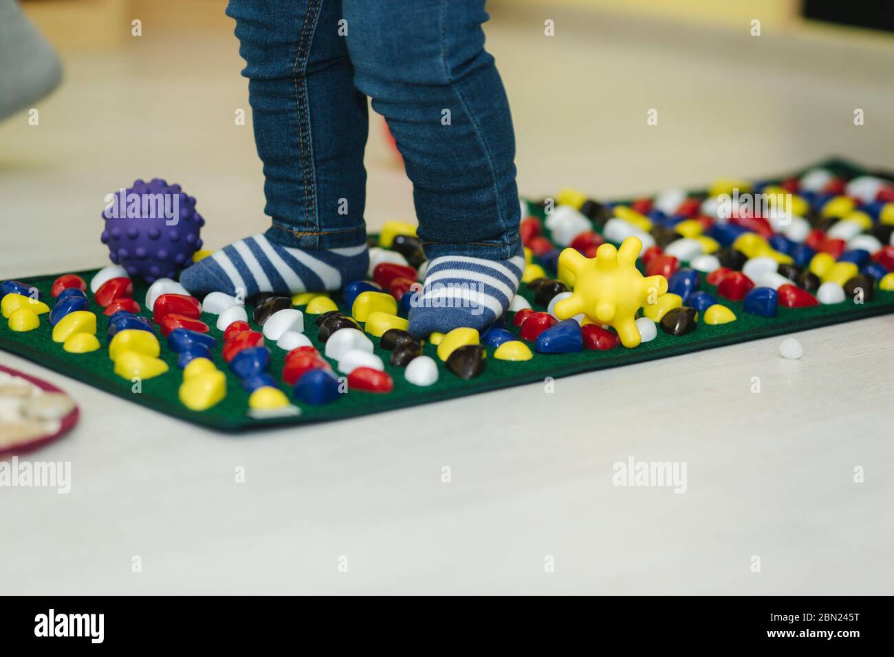 Kid walk on a massage mat in preschool Stock Photo - Alamy