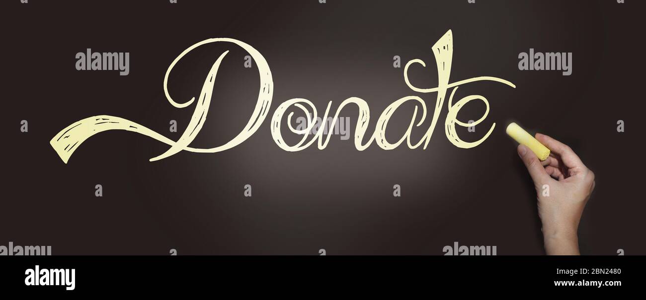 Hand writing the word Donate with chalk on blackboard. Donation help ...