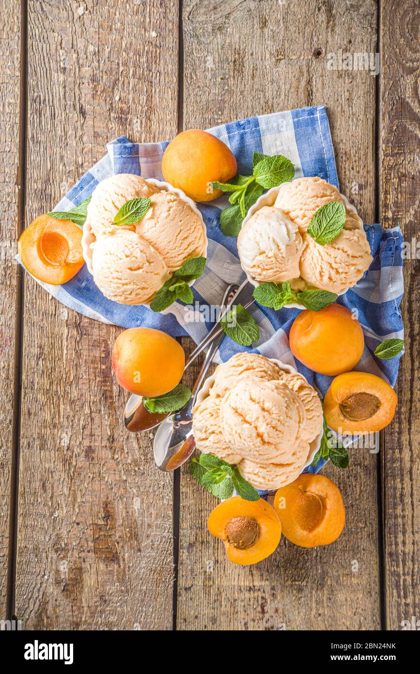 Homemade sweet apricot ice cream. Apricot gelato balls in small bowls ...