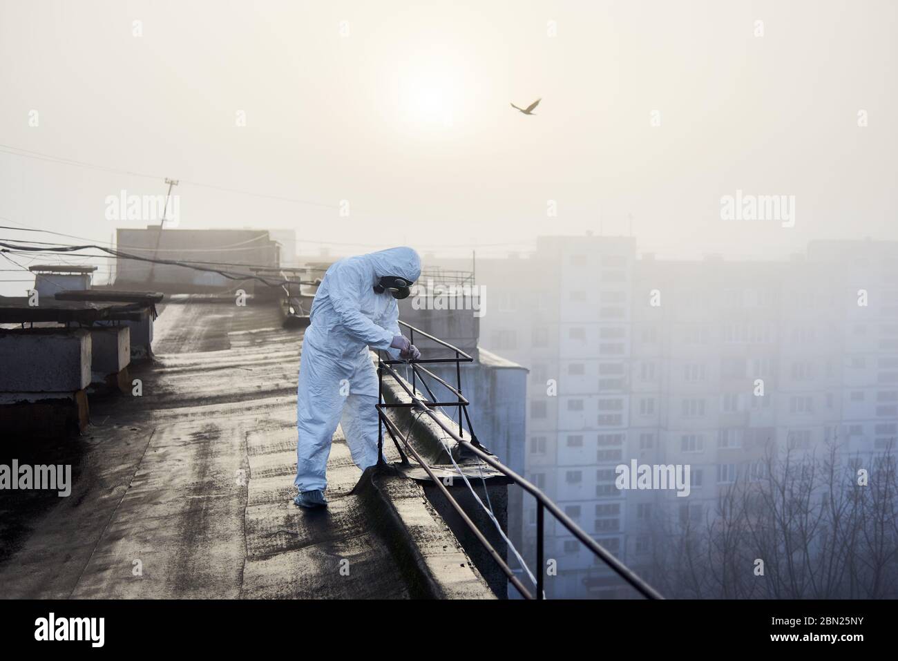 Laboratory worker on the roof conducting tests on subject of air ...