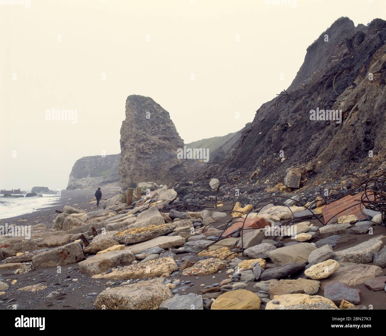 Cliff & beach polluted with coal mining waste, Concrete rubble of ...