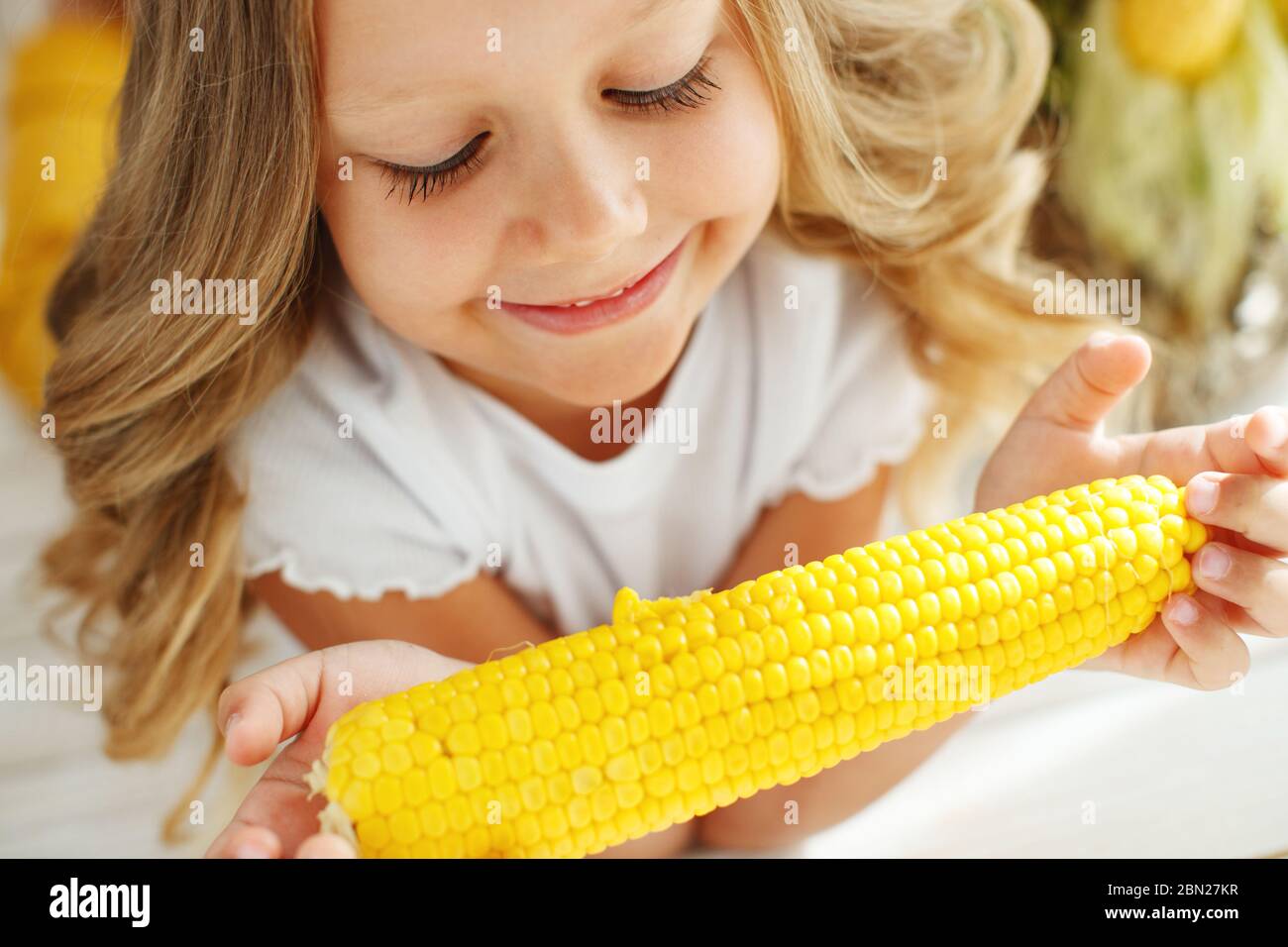 Child girl with corn in the studio Stock Photo - Alamy