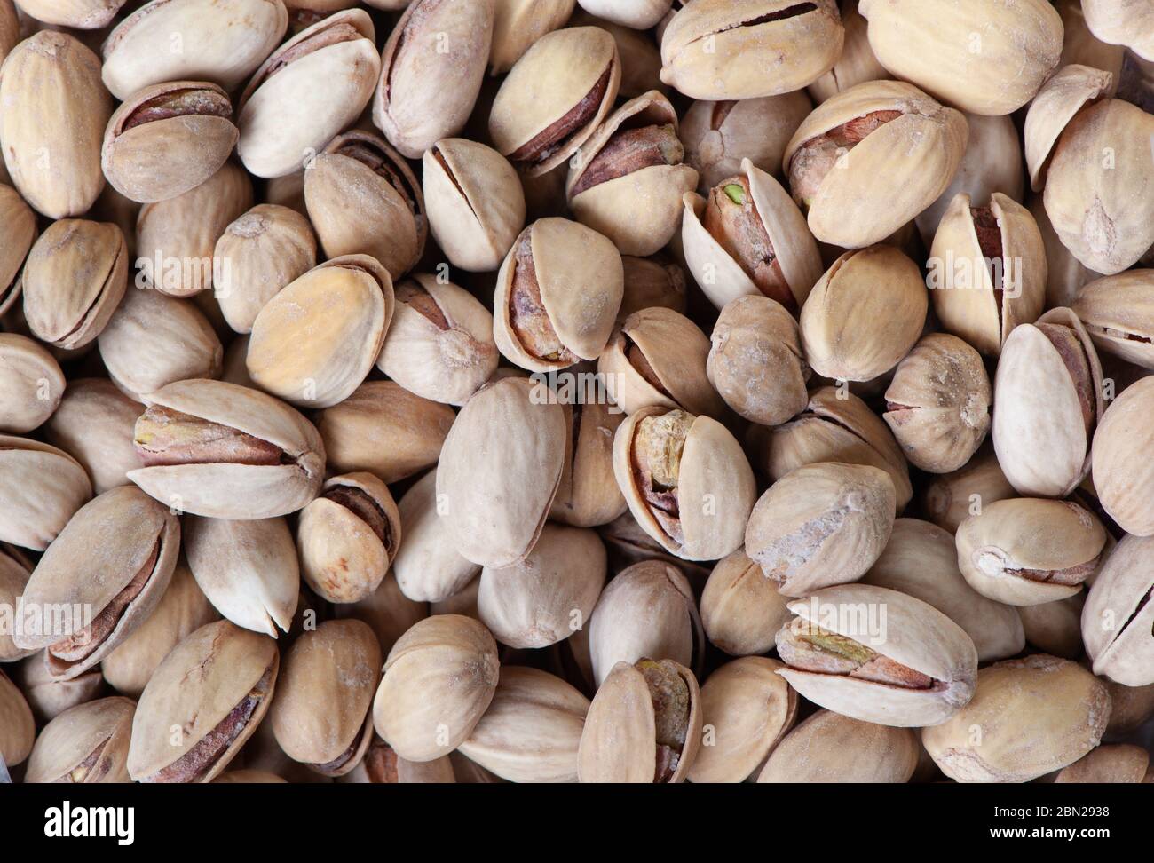Pistachios with shell full background, closeup Stock Photo - Alamy