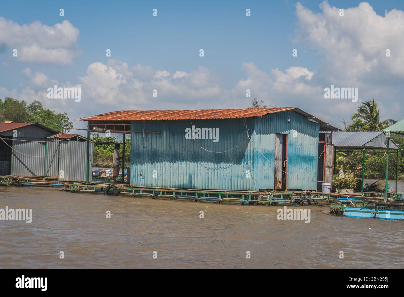 Floating house on the Mekong River in Vietnam, South East Asia. Ho Chi ...