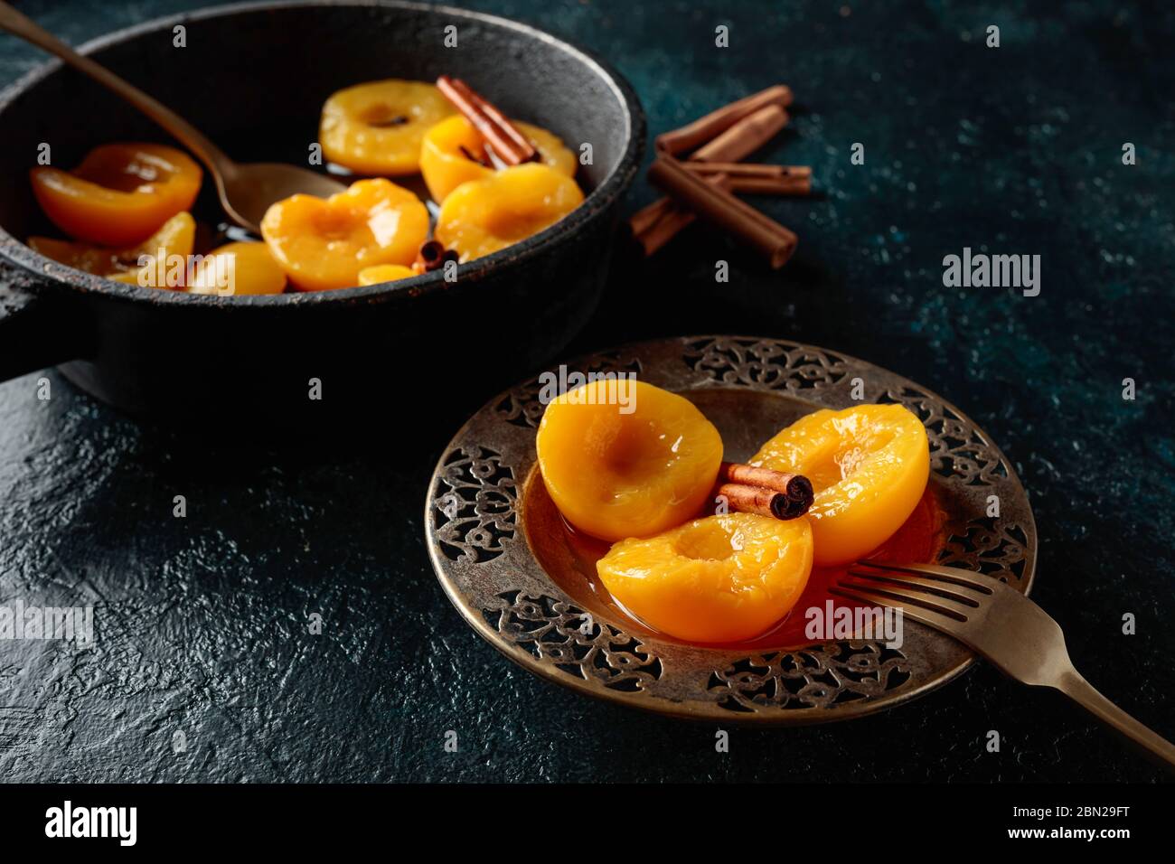 Peach dessert with cinnamon and cloves on a dark background Stock Photo ...