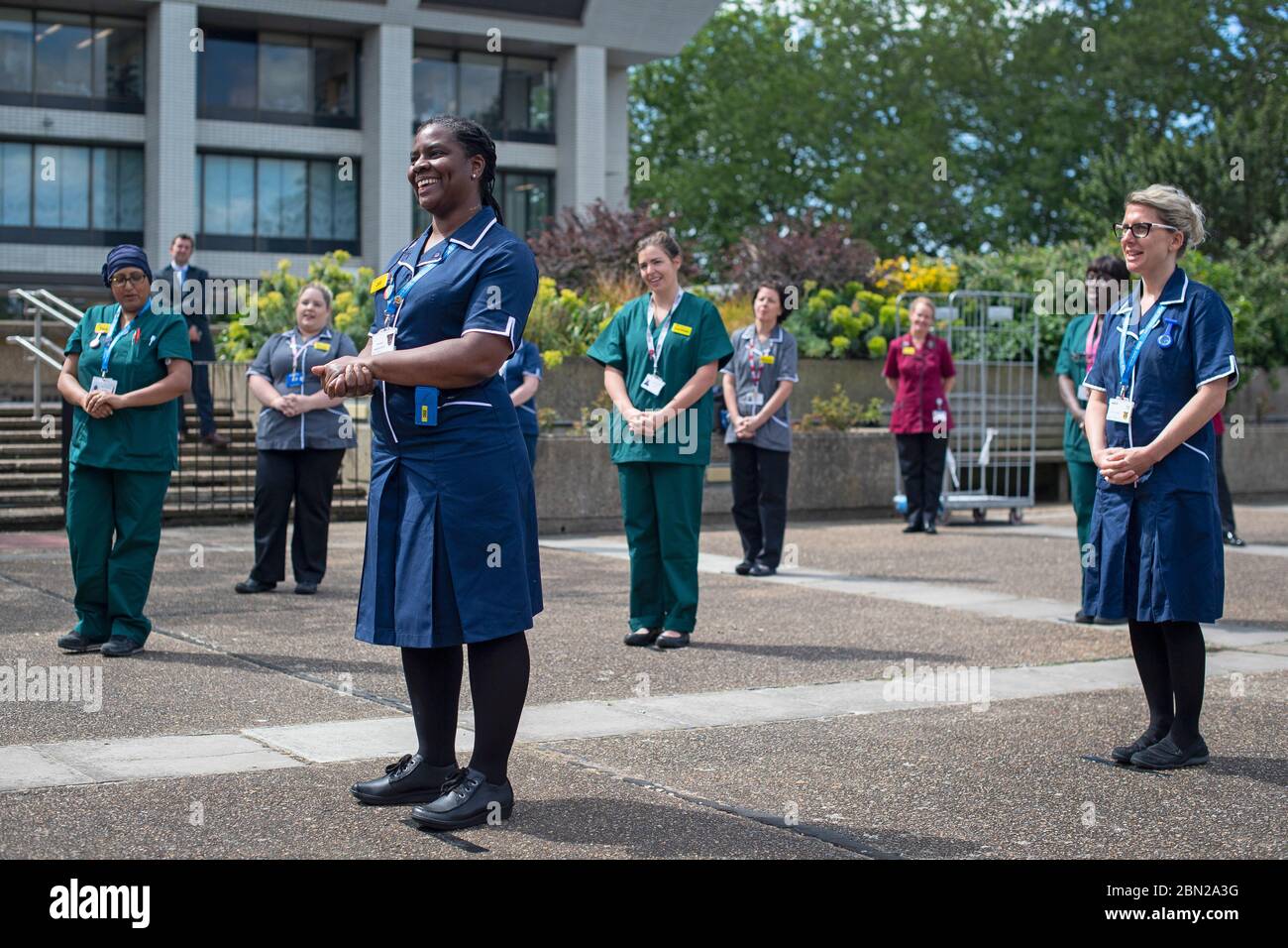 Nurses stand together outside St Thomas's Hospital in central London to ...