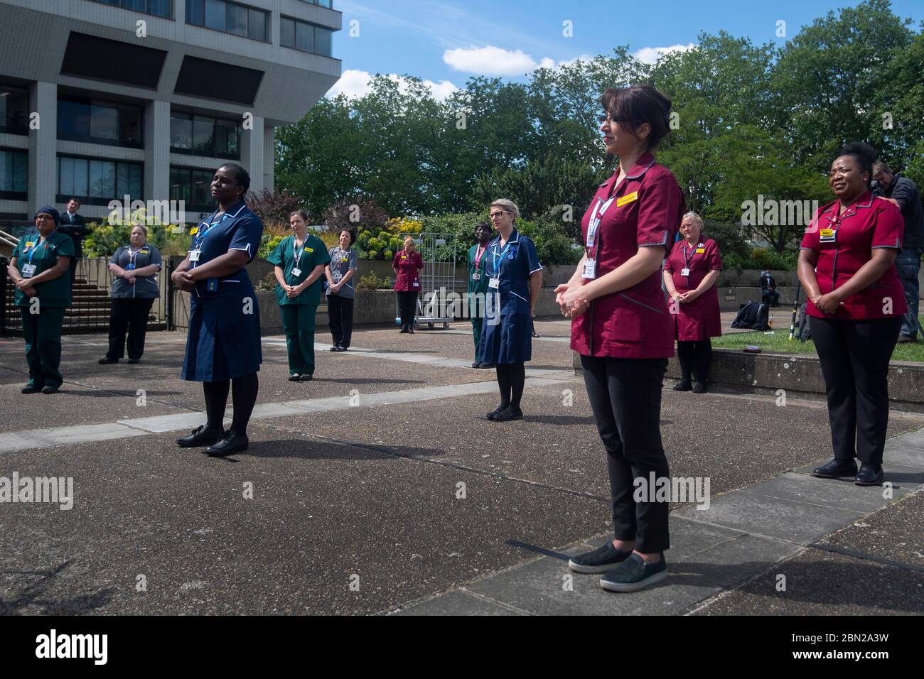Nurses stand together outside St Thomas's Hospital in central London to ...