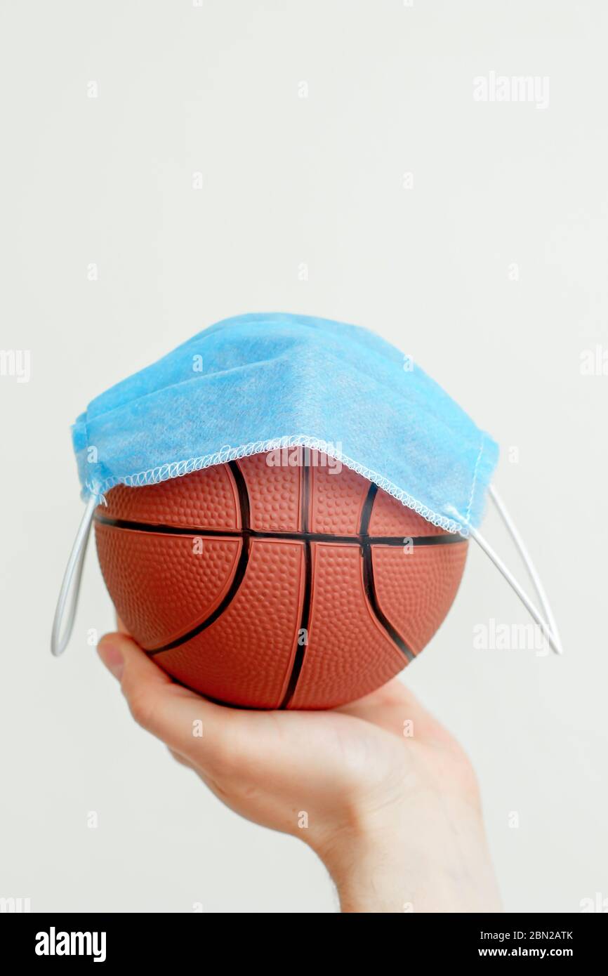 Closeup vertical image of protective medical mask over basketball ball ...