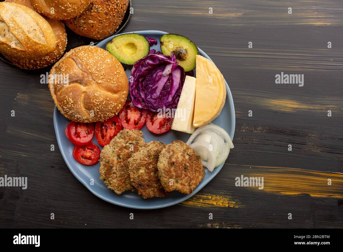 Kaiser with hamburger meat, tomato cheese, avocado, lettuce. It can be ...