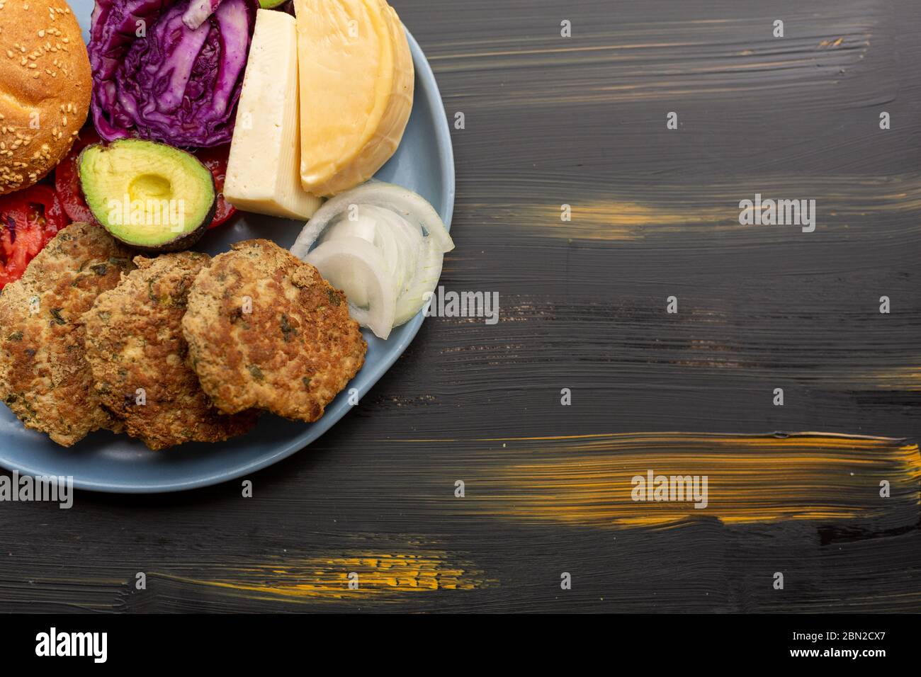 Kaiser with hamburger meat, tomato cheese, avocado, lettuce. It can be ...