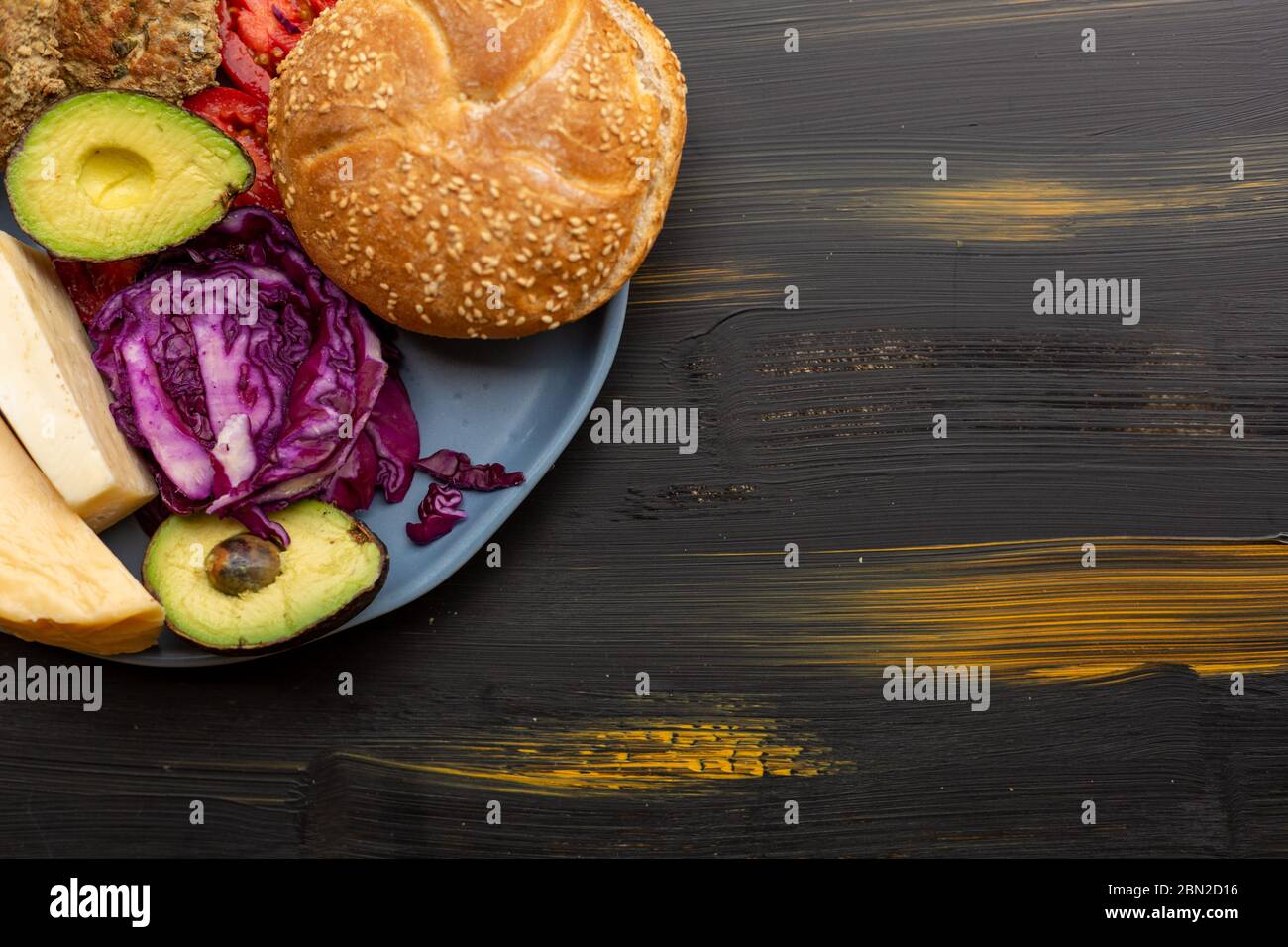 Kaiser with hamburger meat, tomato cheese, avocado, lettuce. It can be ...