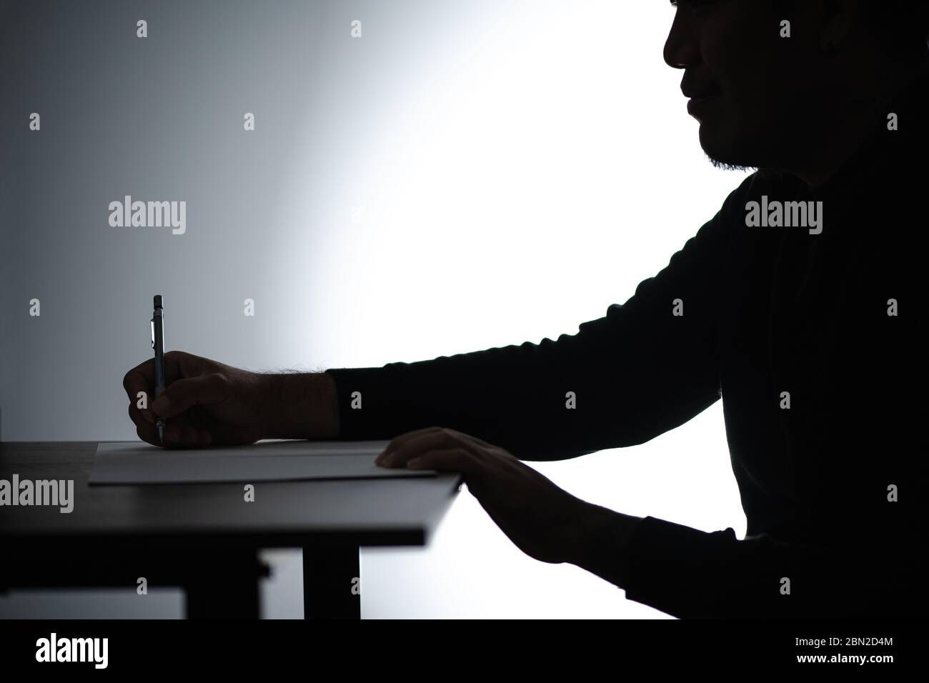Silhouette asian man writing on table. Beared man writing on Notebook ...