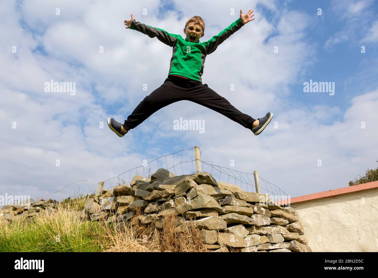 young boy jumping into the air Stock Photo - Alamy