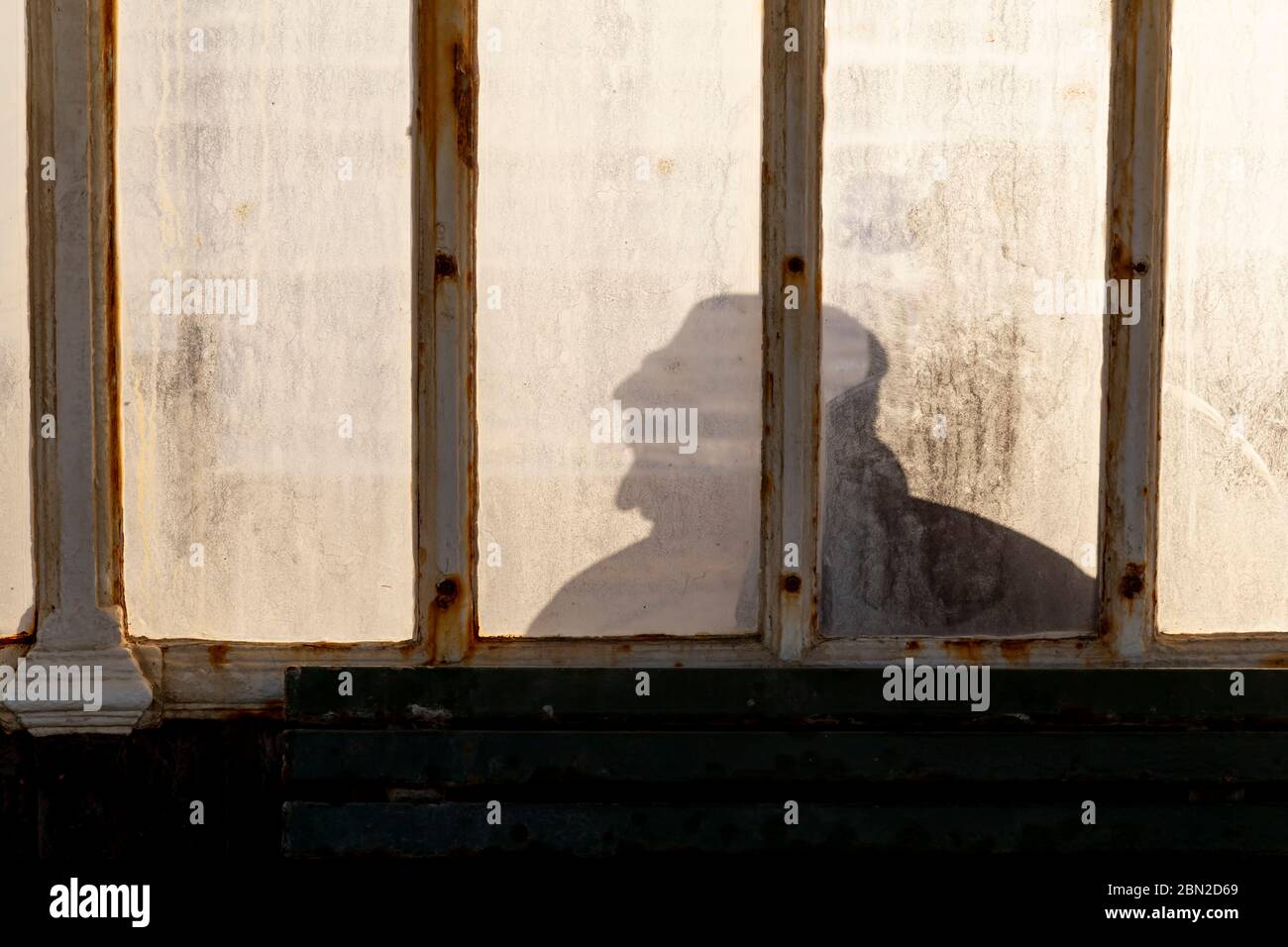 spooky shadow of man at bus stop Stock Photo - Alamy