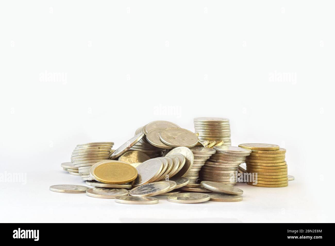 Coins stack and falling coin isolated on a white background Stock Photo ...