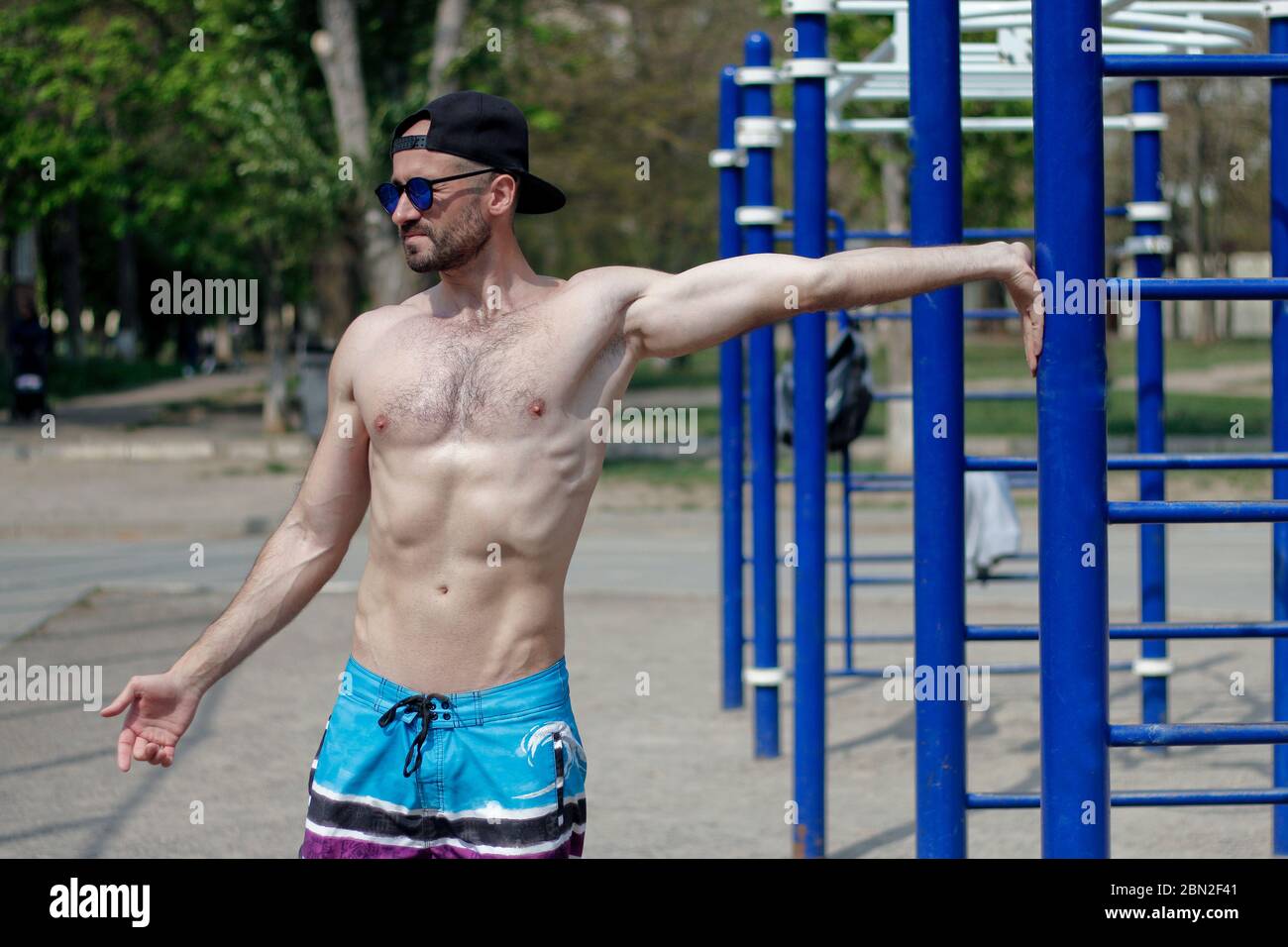 strong young man making stretching exercises after hard training Stock ...