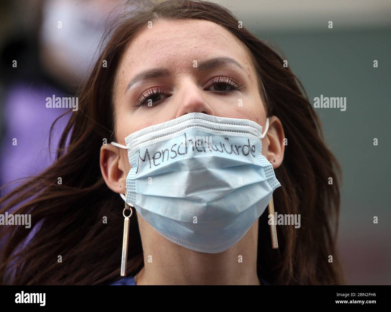 Woman wearing a face mask under the nose hi-res stock photography and ...