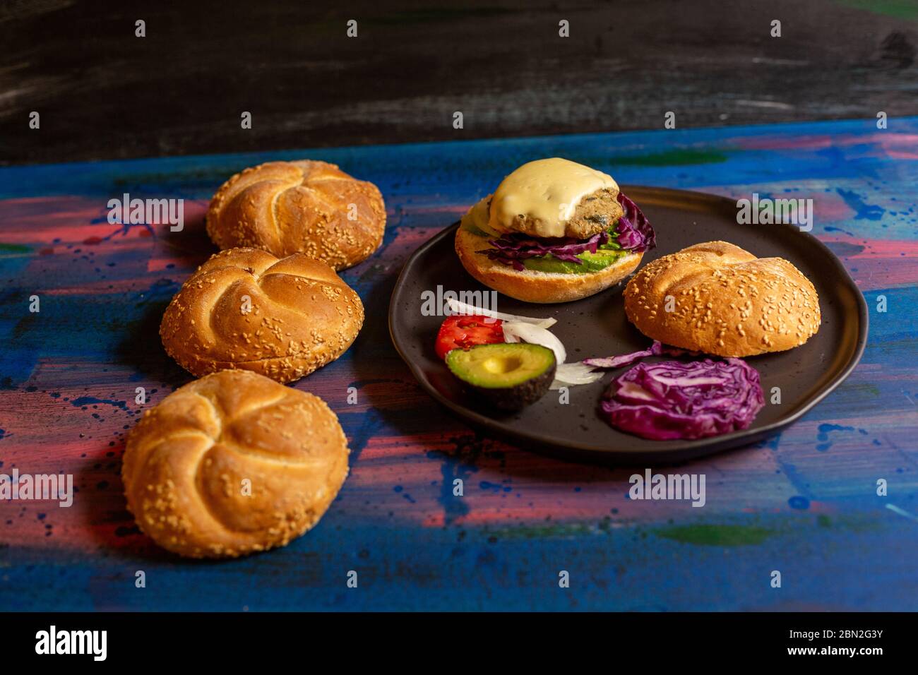 Kaiser with hamburger meat, tomato cheese, avocado, lettuce. It can be ...