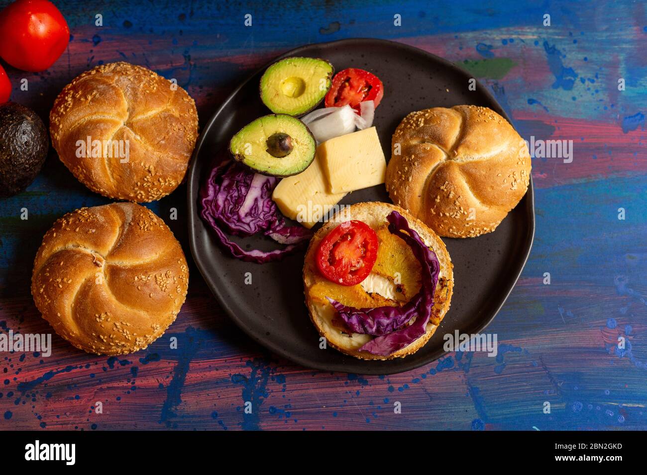 Kaiser with hamburger meat, tomato cheese, avocado, lettuce. It can be ...