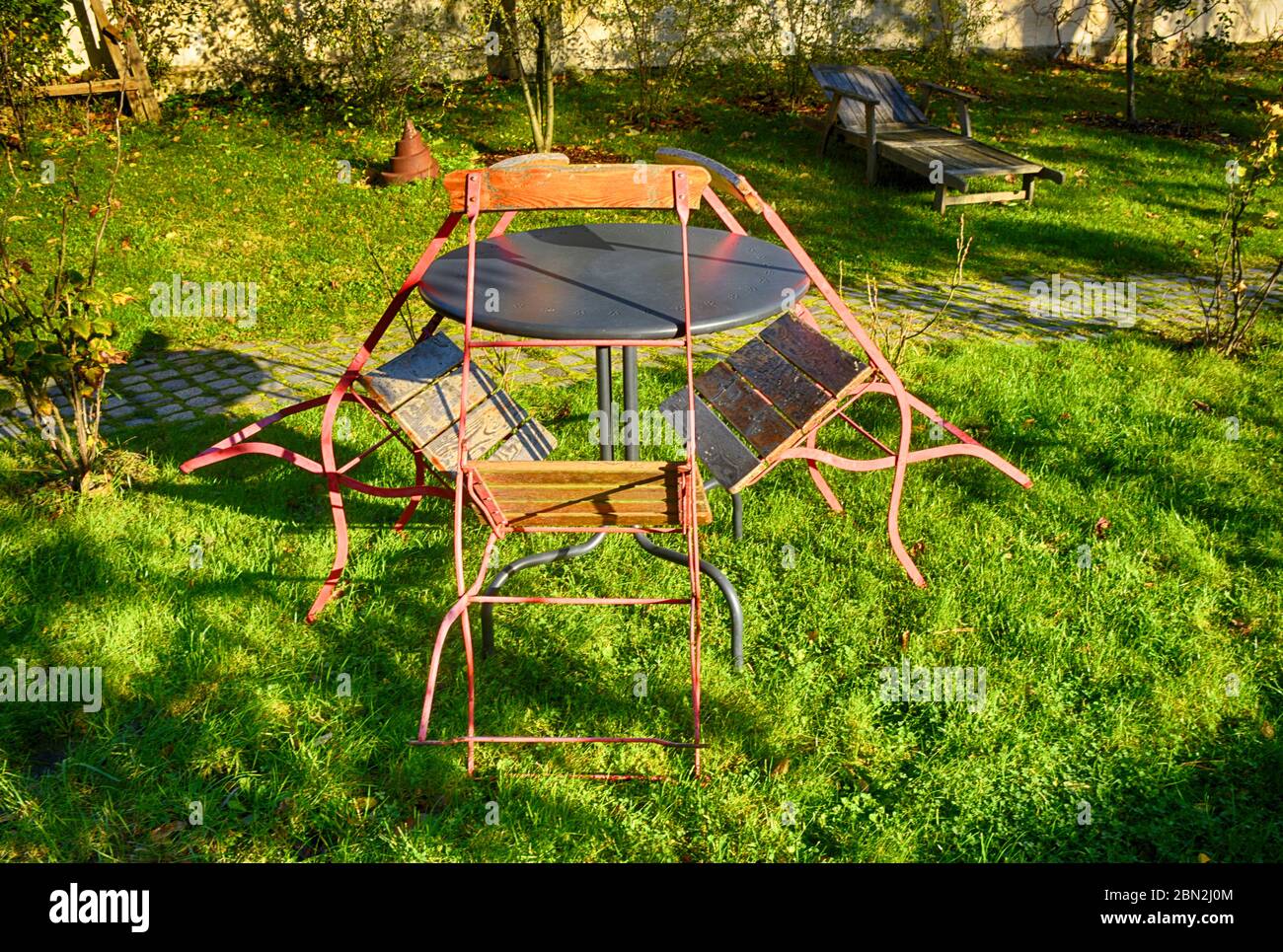 garden scene in autumn with table and chairs outdoor in the sun Stock ...