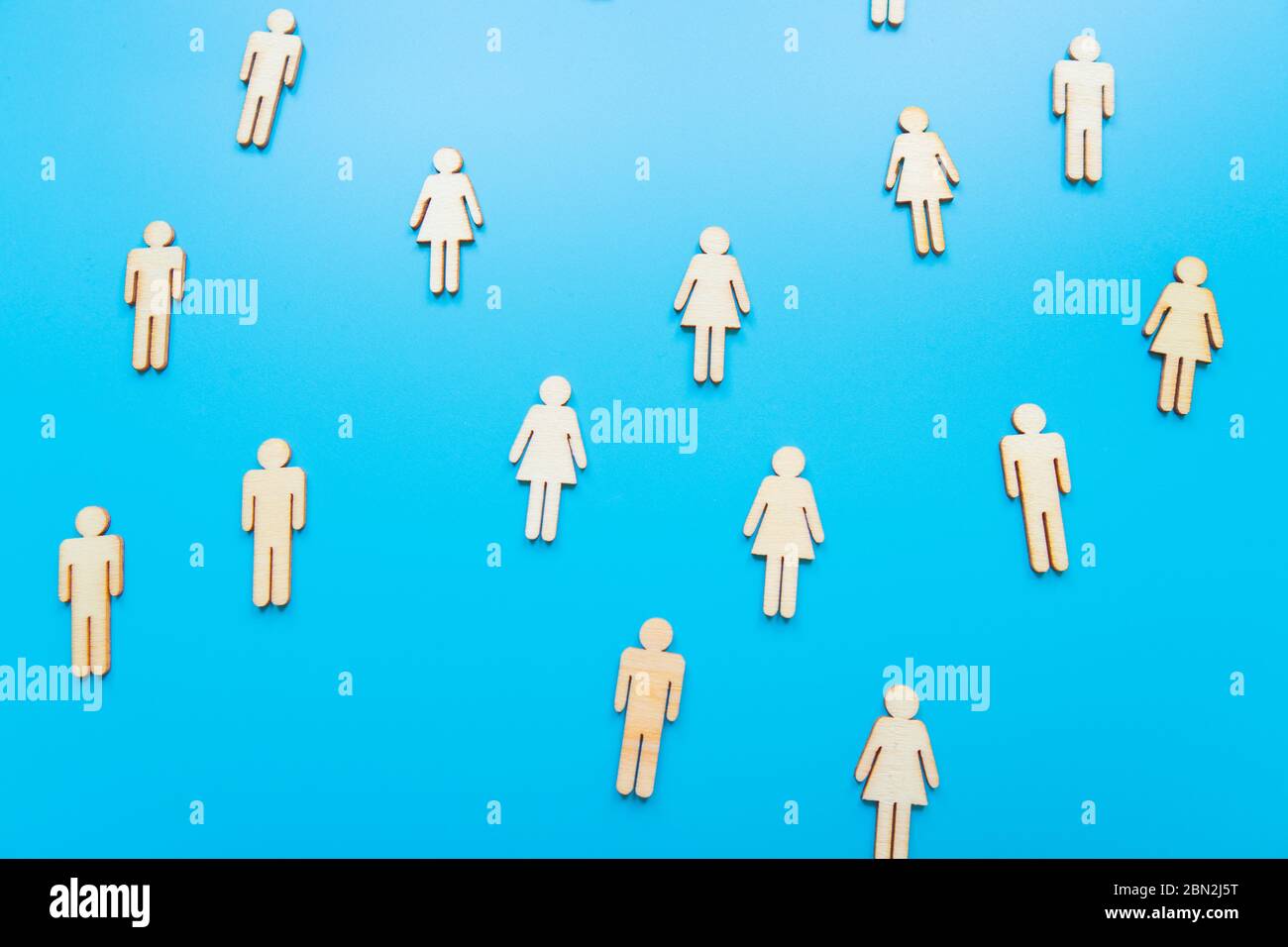 Wooden figures on blue background as a symbol of team building ...