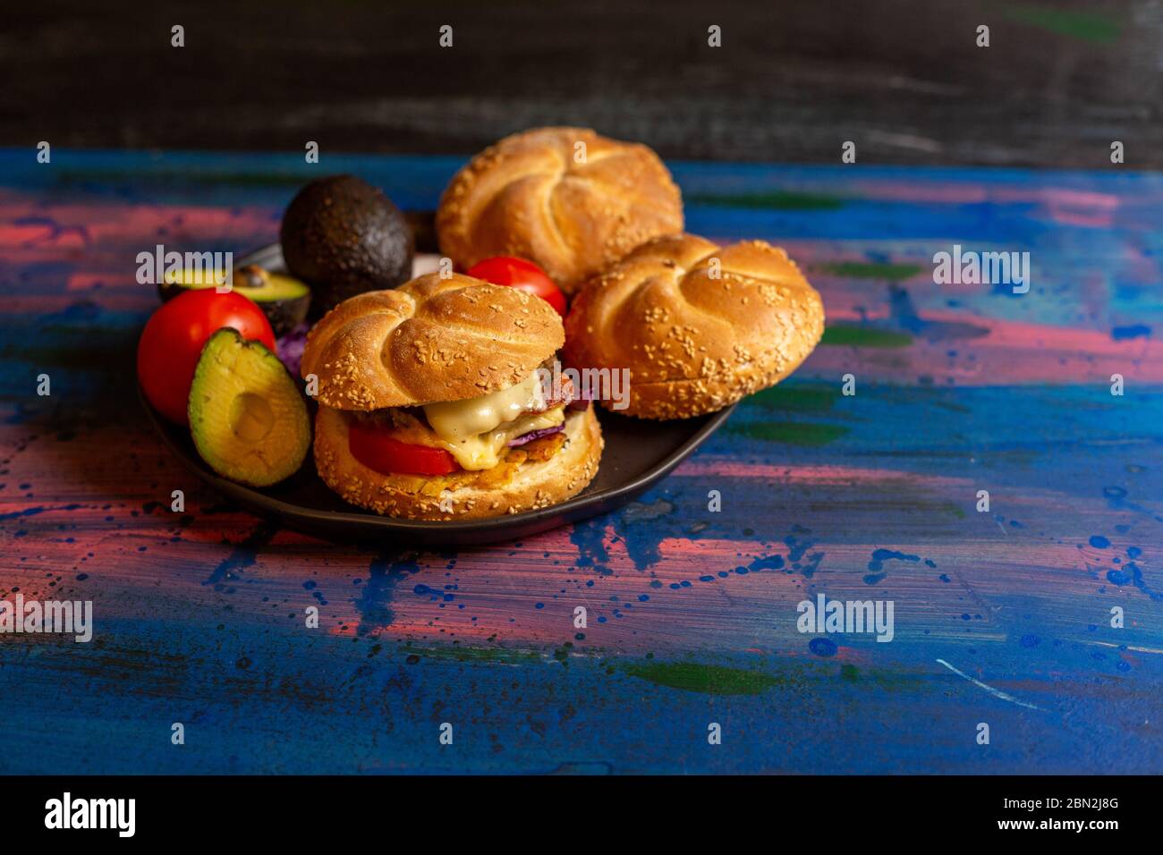 Kaiser with hamburger meat, tomato cheese, avocado, lettuce. It can be ...