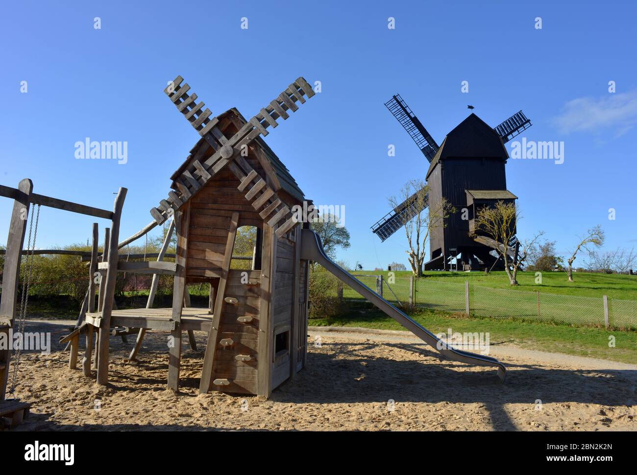 Children playground with wooden windmill and historic vintage windmill ...